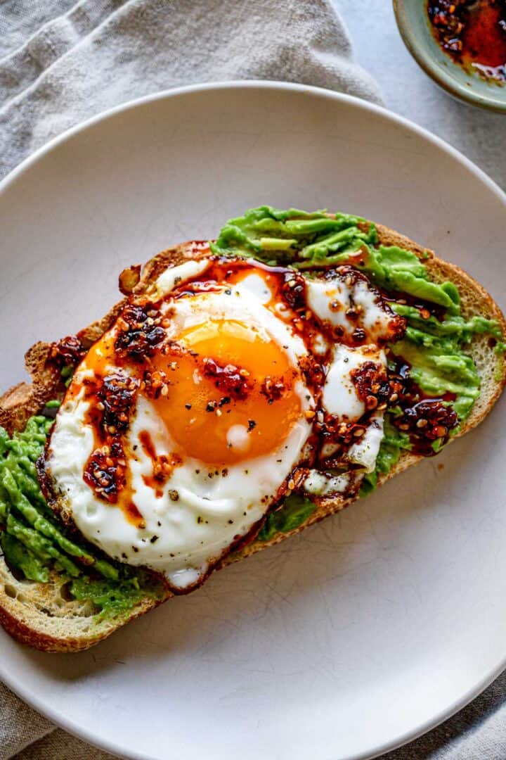 Fried Egg Avocado Toast with Chili Crunch - Grateful Grazer